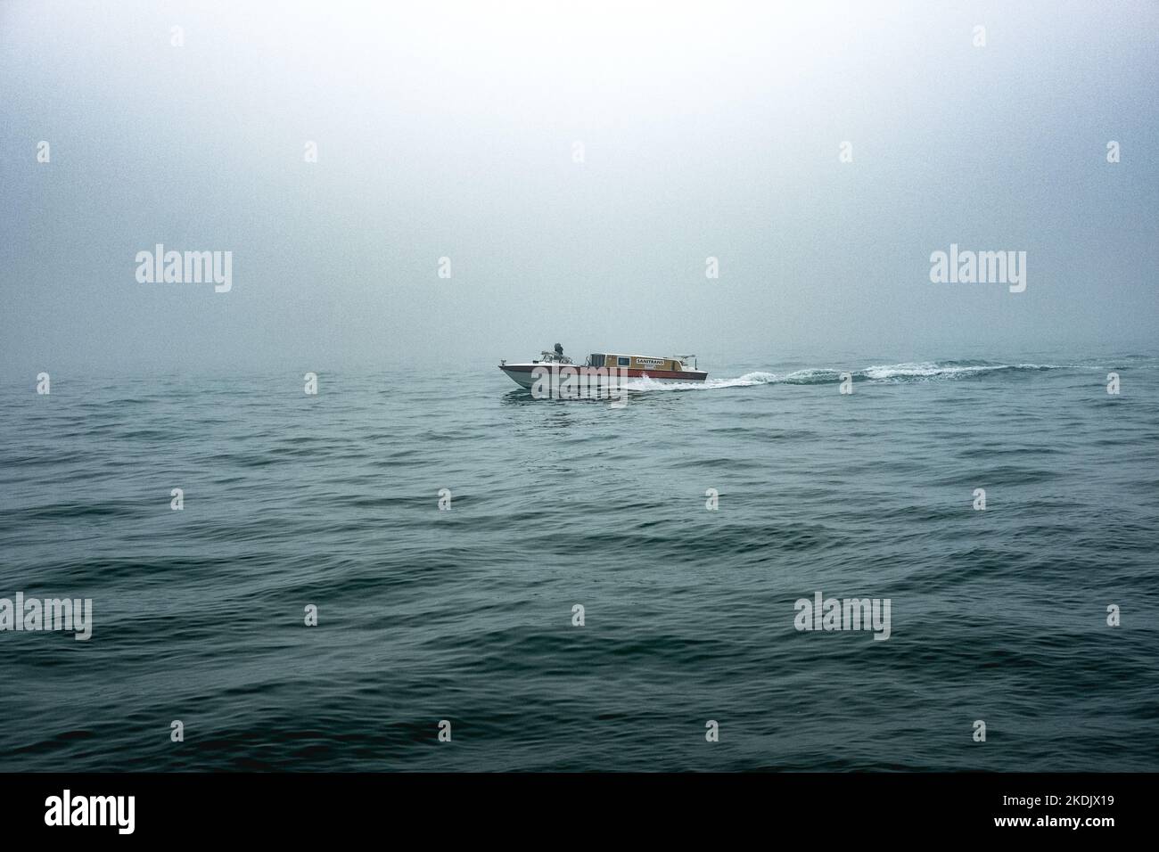 Boat in the mist Stock Photo - Alamy