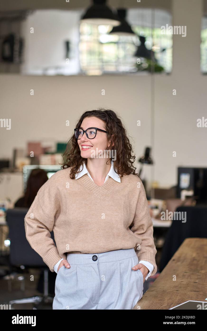 Young happy professional business woman standing in office, vertical portrait Stock Photo - Alamy