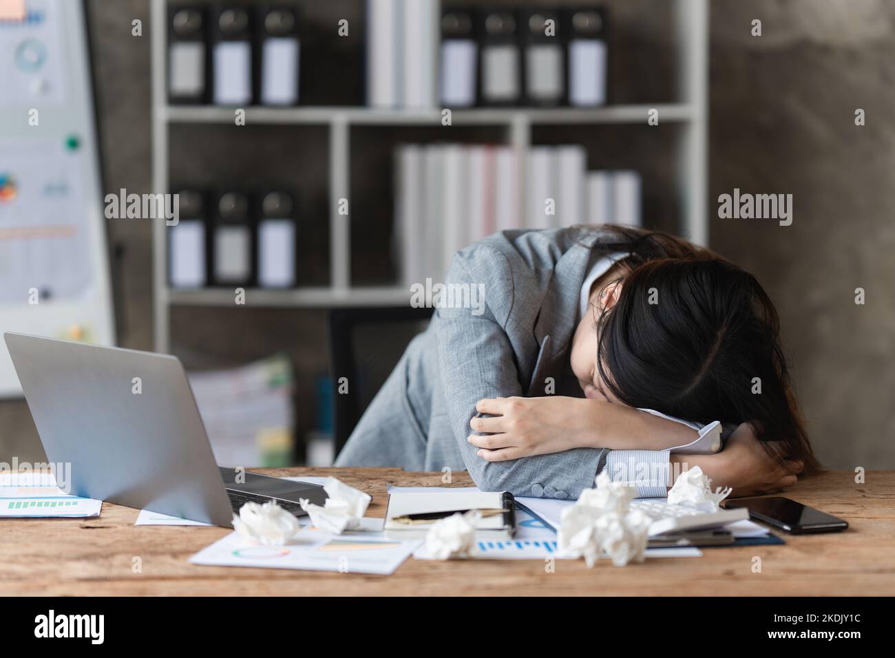 Stressed Asian business woman worry about marketing plan of this years ...