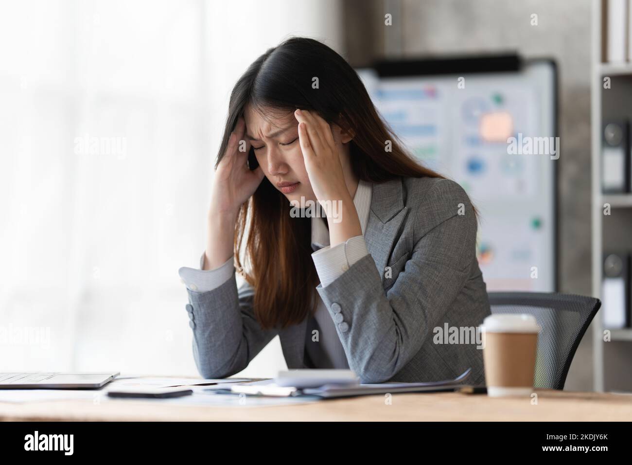 Stressed Asian business woman worry about marketing plan of this years ...