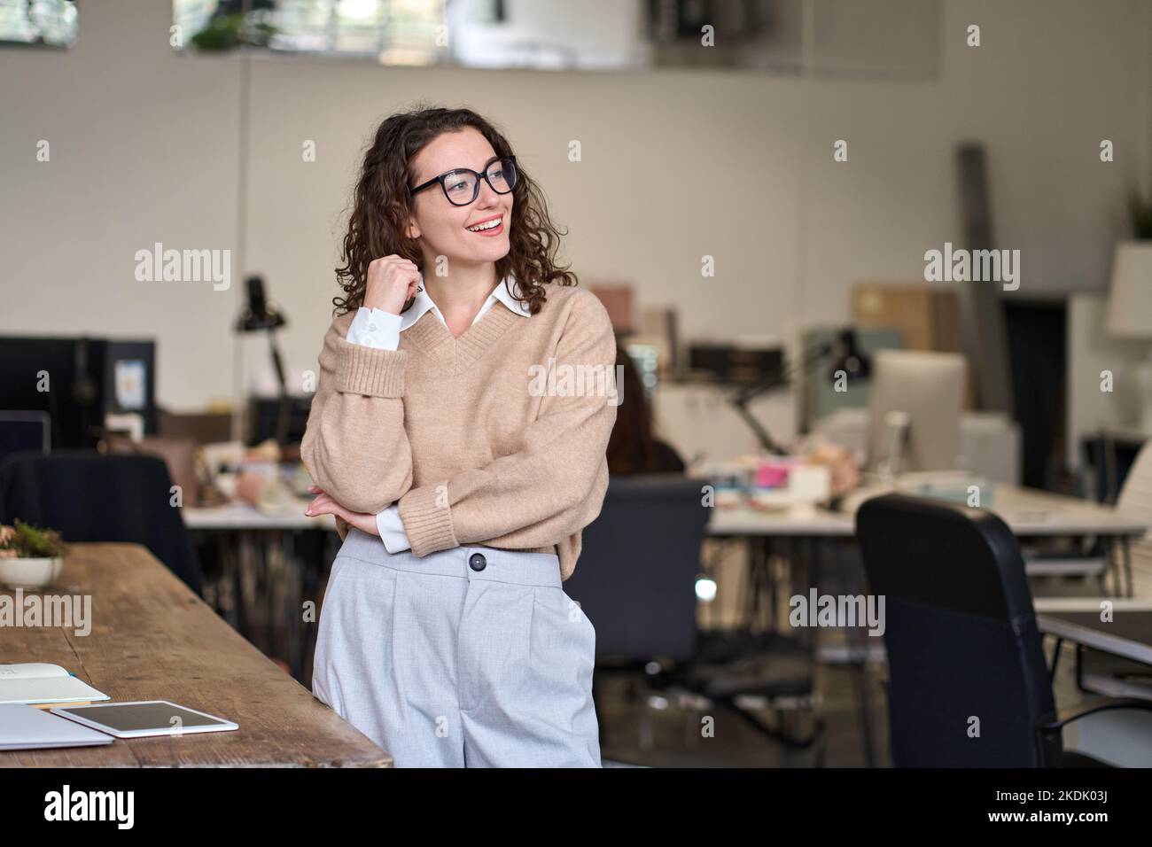 Young positive happy professional business woman standing in office ...