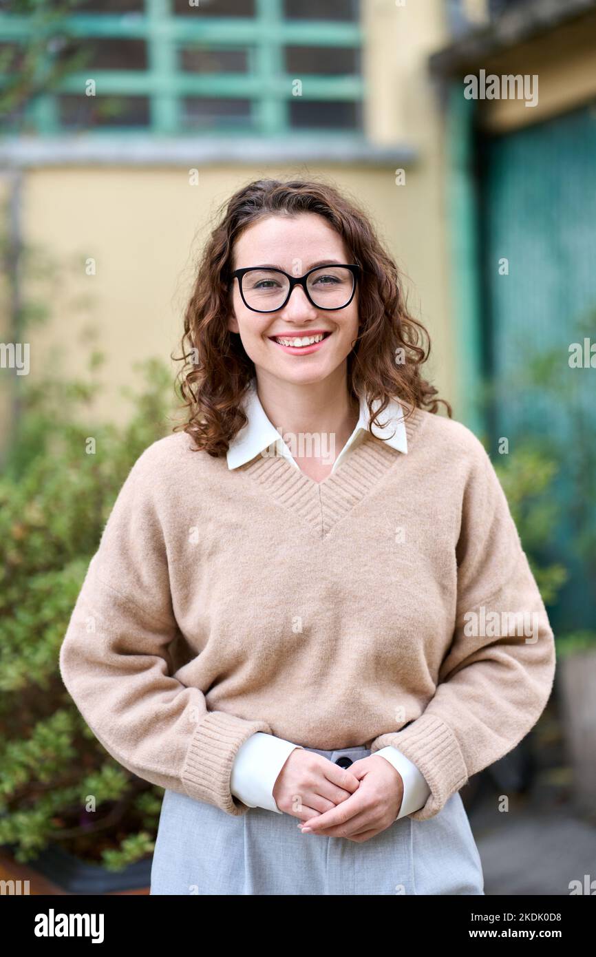 Young smiling professional business woman standing outdoor, vertical ...