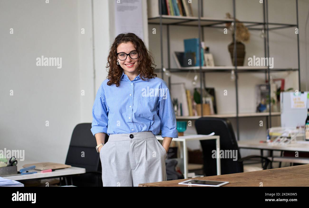 Young smiling business woman manager standing in office, portrait Stock ...