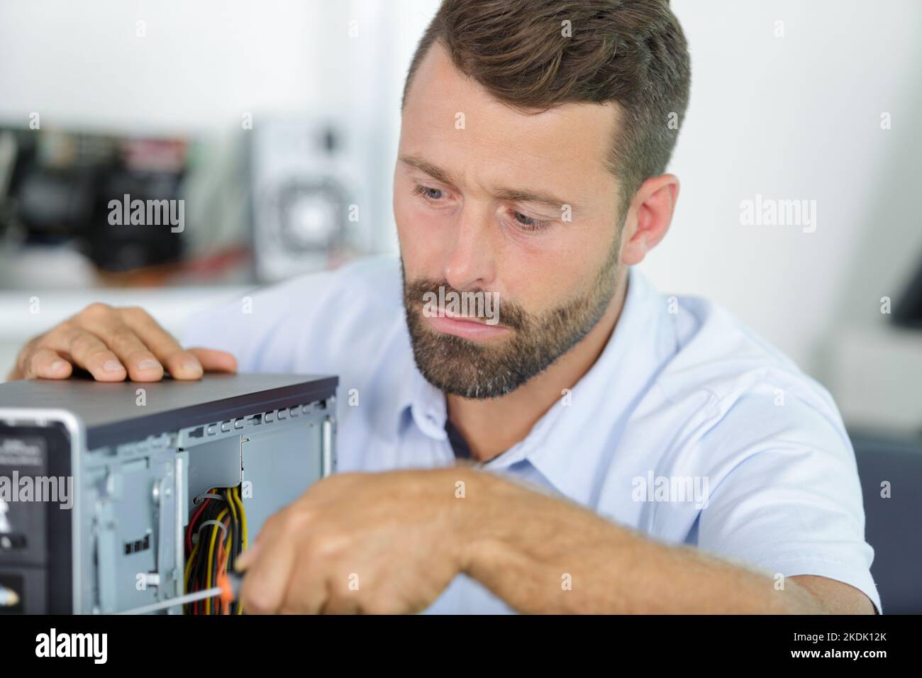 man is repairing broken pc with a screw driver Stock Photo - Alamy