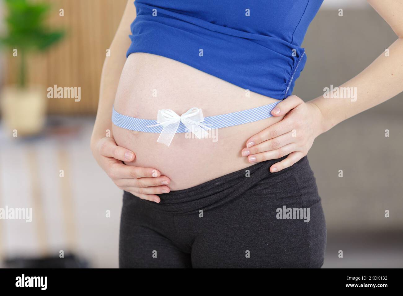 Pregnant belly pink ribbon hi-res stock photography and images - Alamy