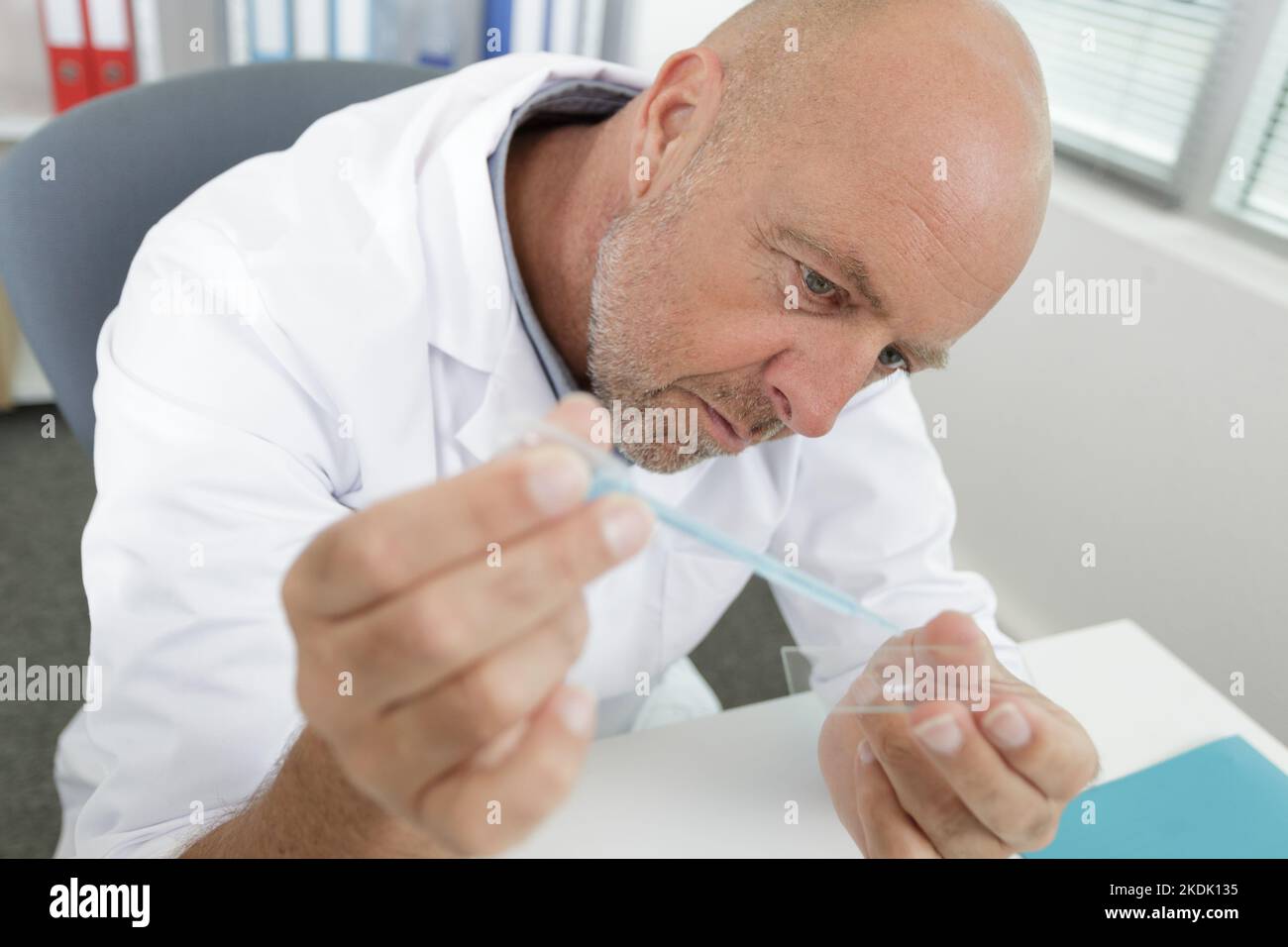 man scientist mixes a liquid form of medication Stock Photo - Alamy