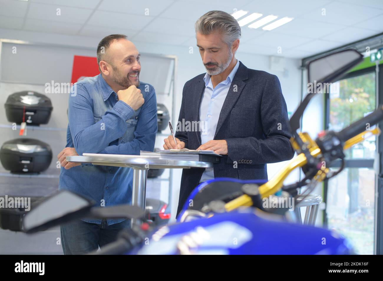 customer signs to buy a motorbike Stock Photo - Alamy