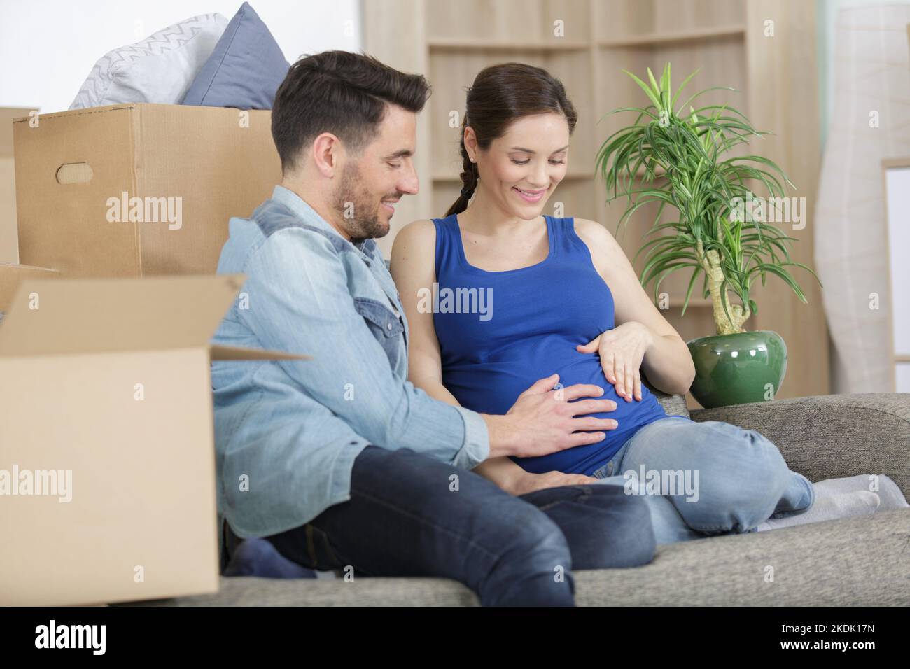 young pregnant couple relaxing after moving out Stock Photo - Alamy
