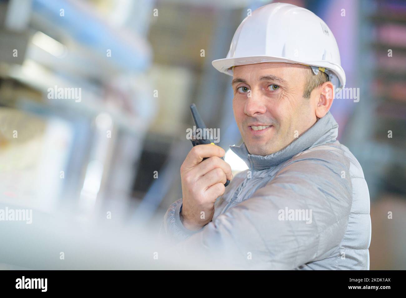 industrial factory worker talking on walkie talkie Stock Photo - Alamy