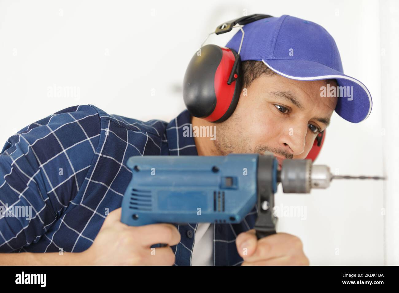 construction site workers drilling with an electric drill Stock Photo ...