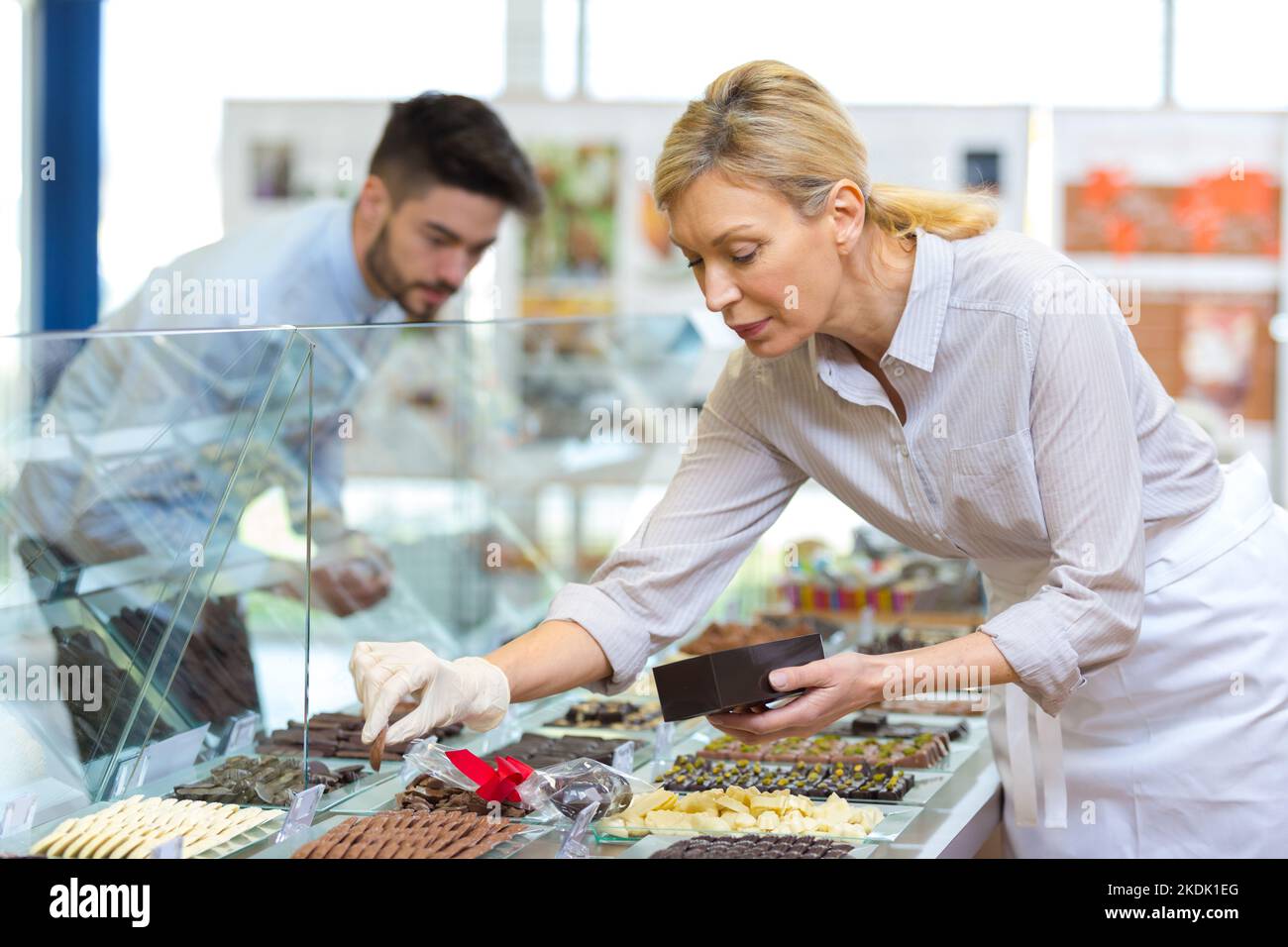 Woman selling chocolate hi-res stock photography and images - Alamy