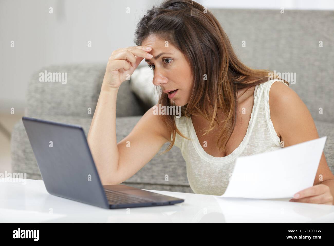 worried woman reading bad news in letter Stock Photo - Alamy