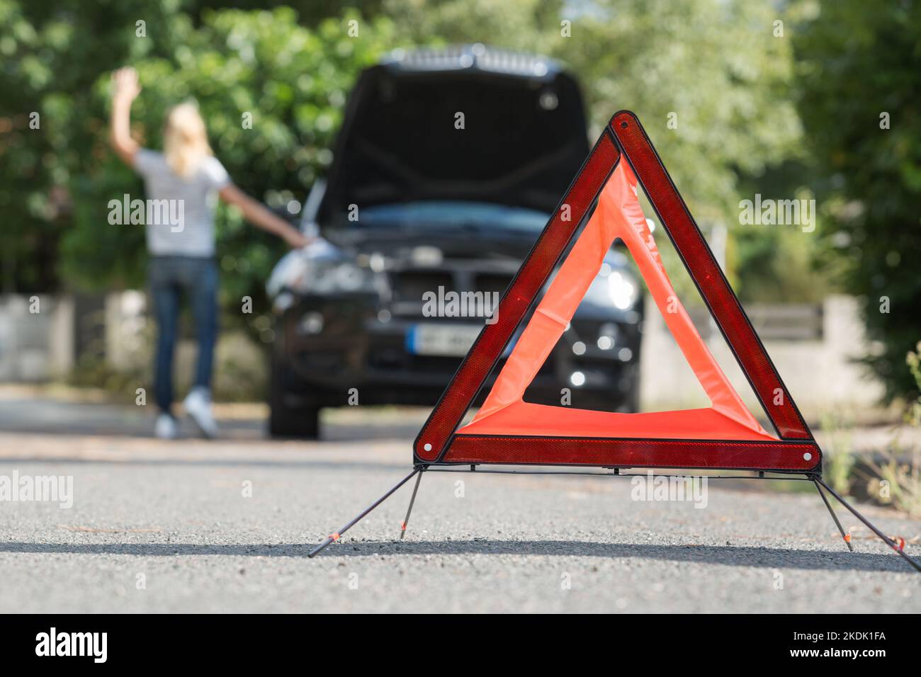 safety triangle on roadside after womans car has broken down Stock ...