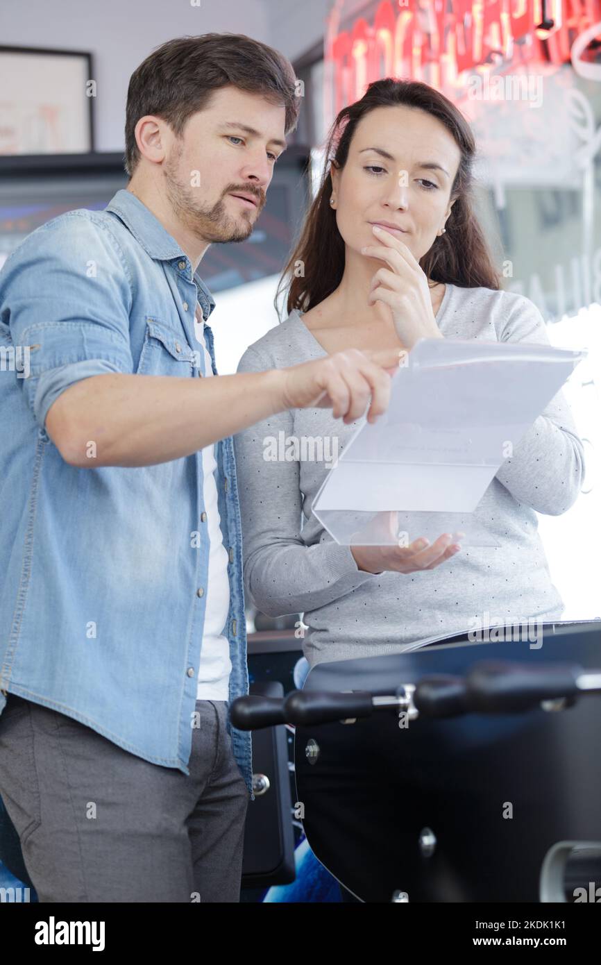 man and woman checking paperwork Stock Photo - Alamy