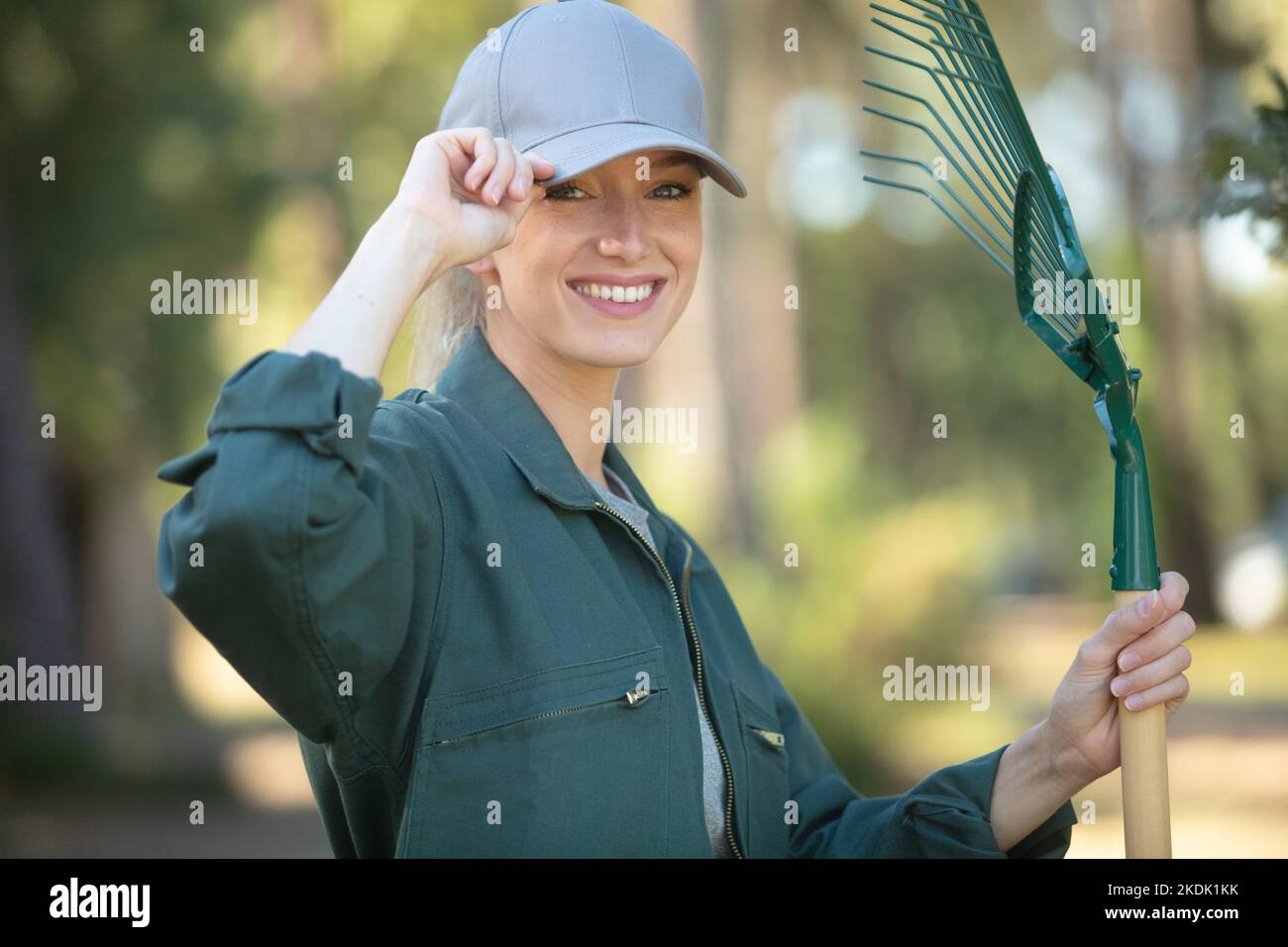 female gardener holding a rake Stock Photo - Alamy