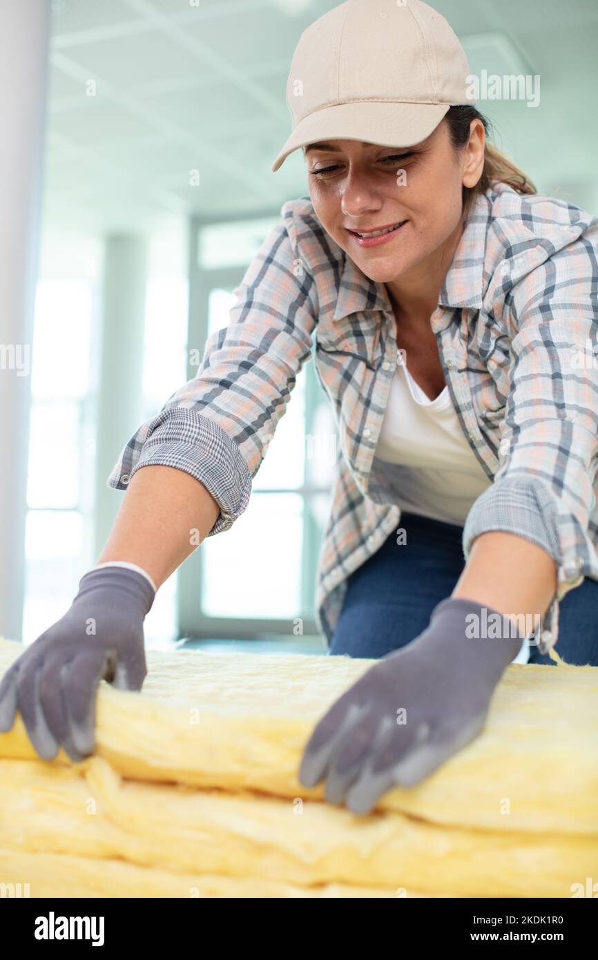 female worker checking the insulation floors Stock Photo - Alamy