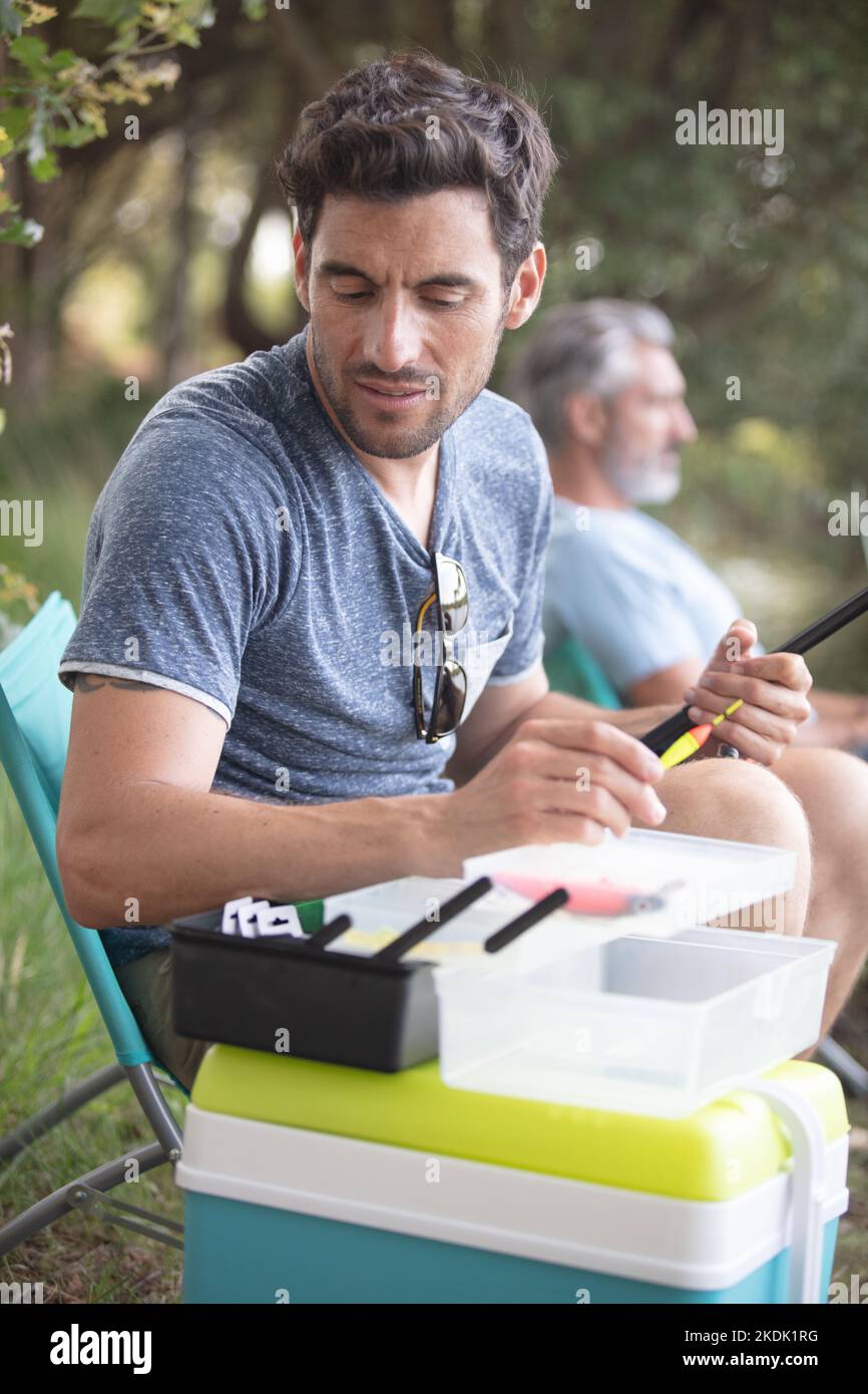 two friends are fishing in the summer Stock Photo - Alamy