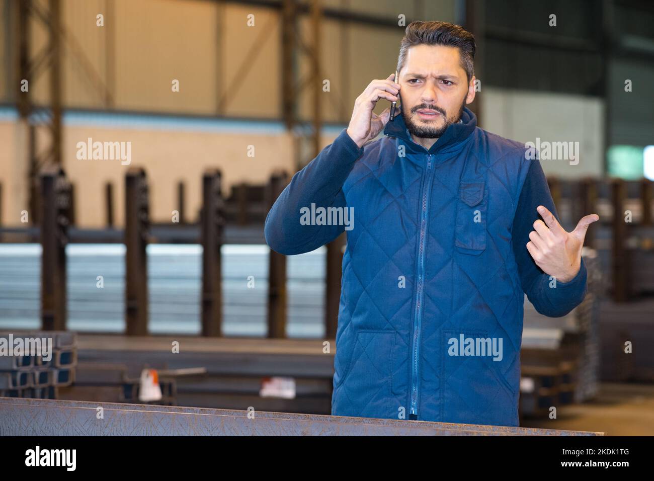 man calling with a cell phone in a factory Stock Photo - Alamy