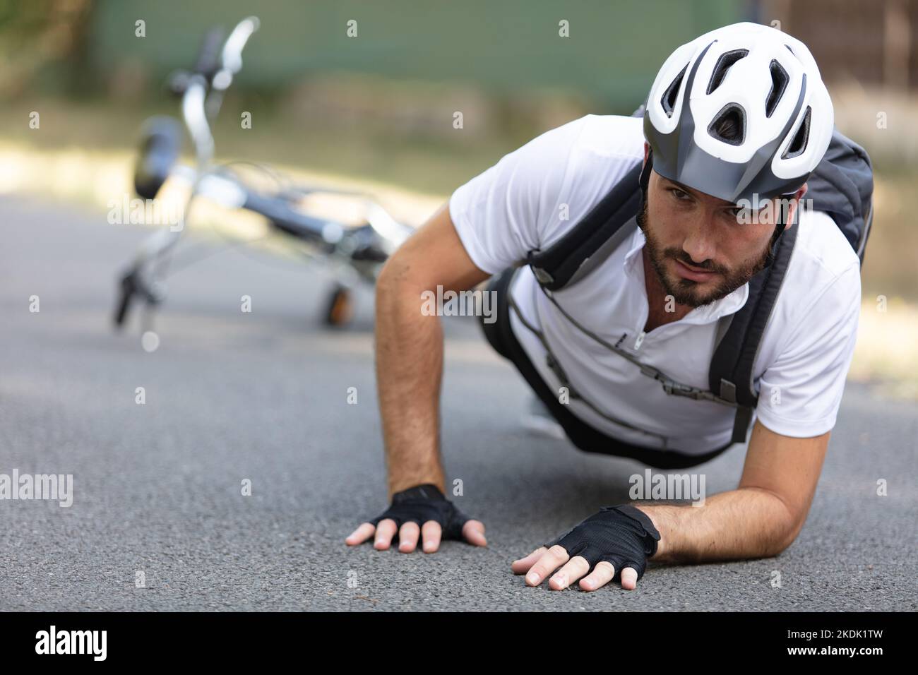 man cyclist fell off road bike while cycling Stock Photo - Alamy