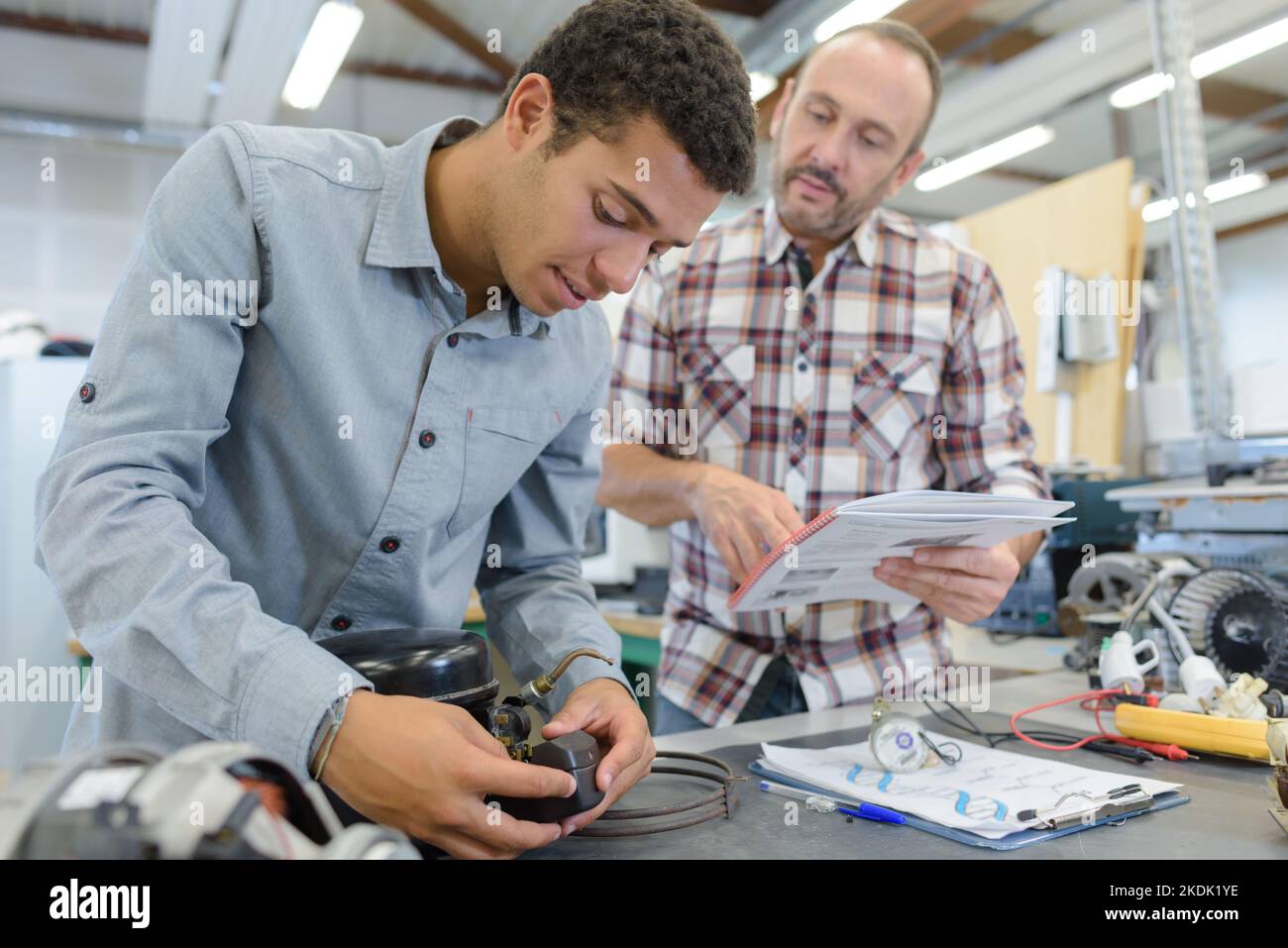 man plugging the wire into a robotic vehicle Stock Photo - Alamy