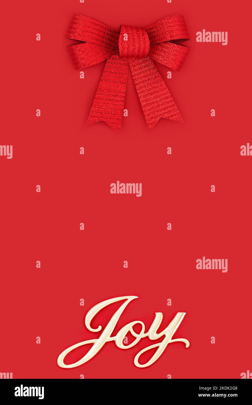Christmas joy sign with red bow ribbon. Minimal Xmas composition for ...