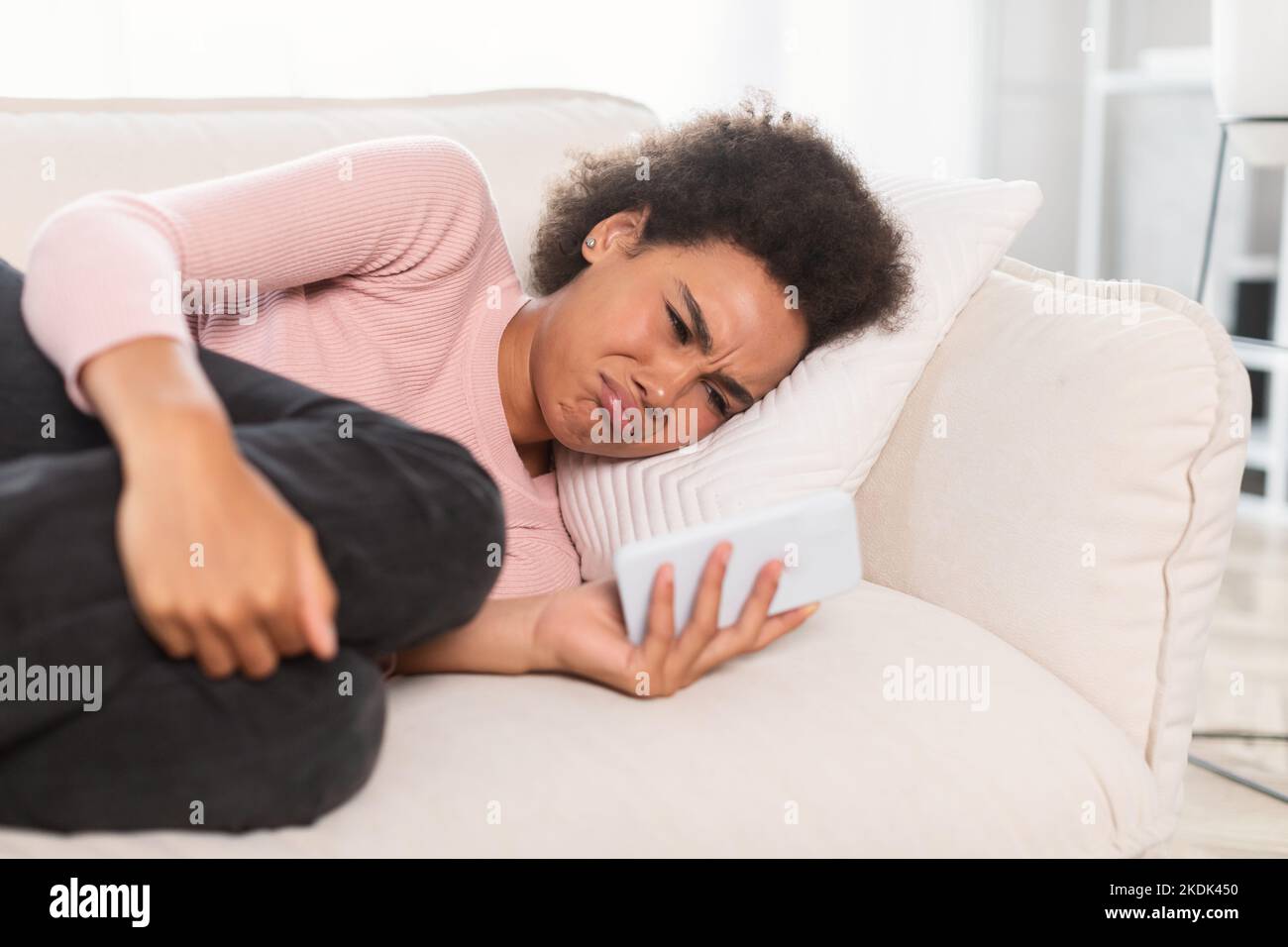 Sad crying millennial african american woman read bad message on phone ...