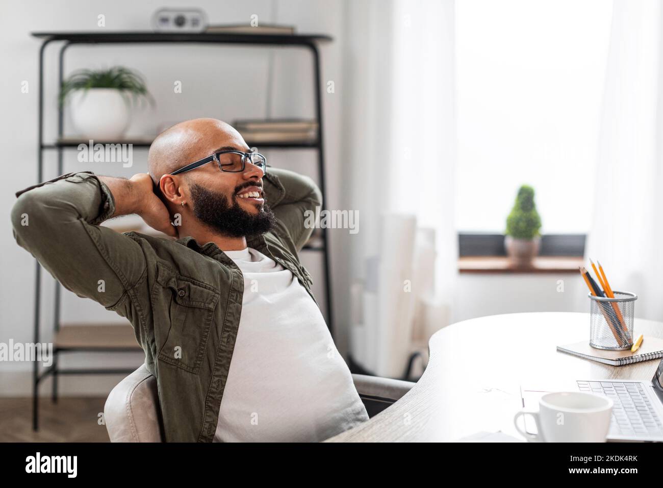 Positive mature freelancer man leaning back in chair, relaxing after ...
