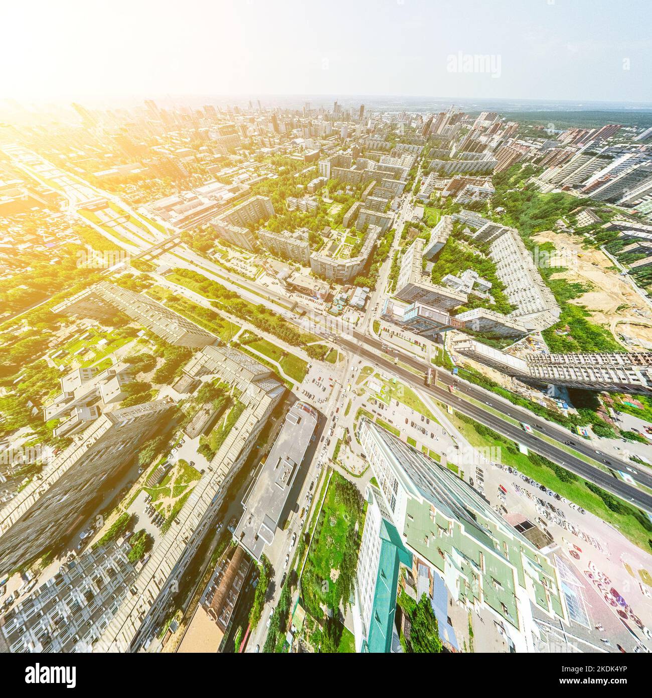 Aerial city view with crossroads and roads, houses, buildings, parks ...