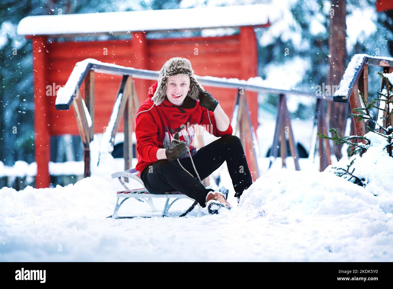 Young cheerful caucasian man is wearing worm red sweatshirt and fun ...