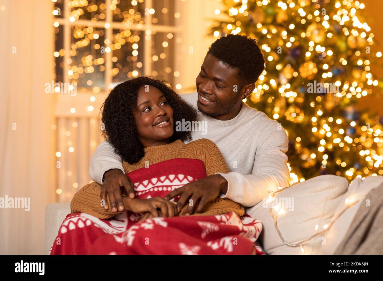 Cheerful Millennial African American Husband Hugging Wife With Plaid