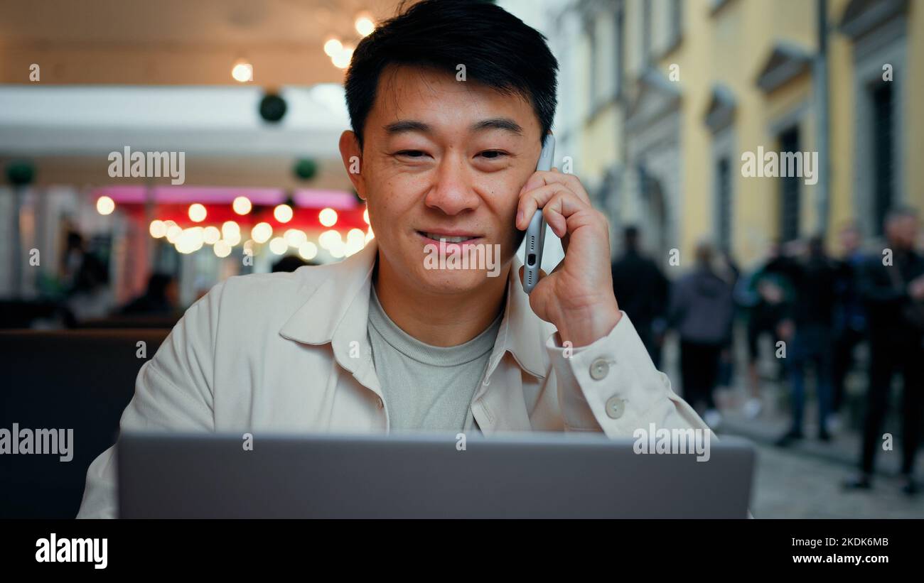 Man talking on phone looking at laptop screen male tourist client ...