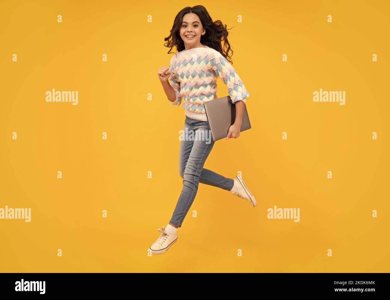 Back to school, Teenager school girl with laptop computer. Run and jump ...