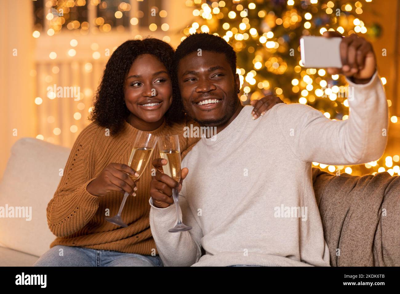 Glad Millennial Black Couple Cheers With Glasses Of Champagne Man