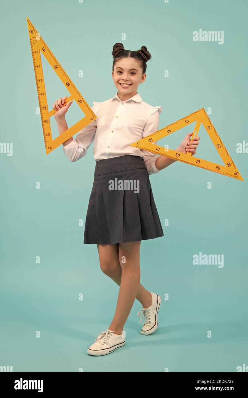 Schoolgirl in school uniform hold mathematics measure. Metric ...