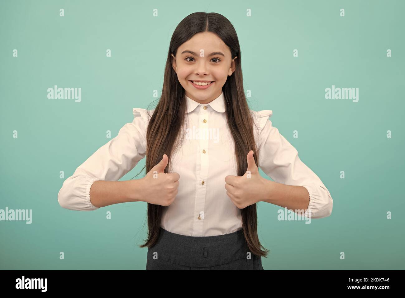 Optimistic cool teenager child girl with thumb up isolated on yellow ...