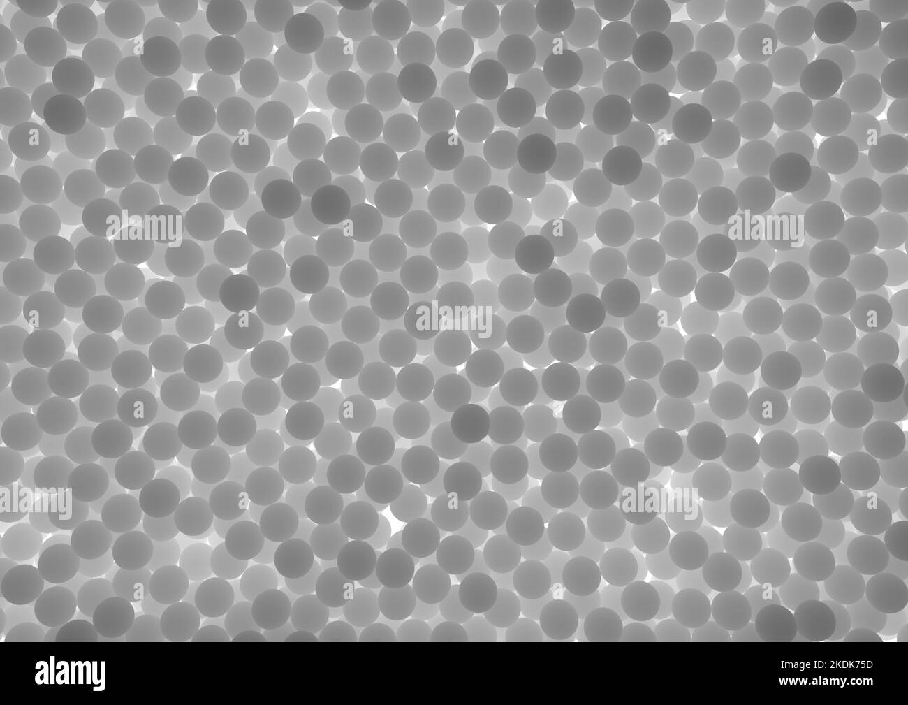 An array of translucent white rubber balls spread out to form a solid ...