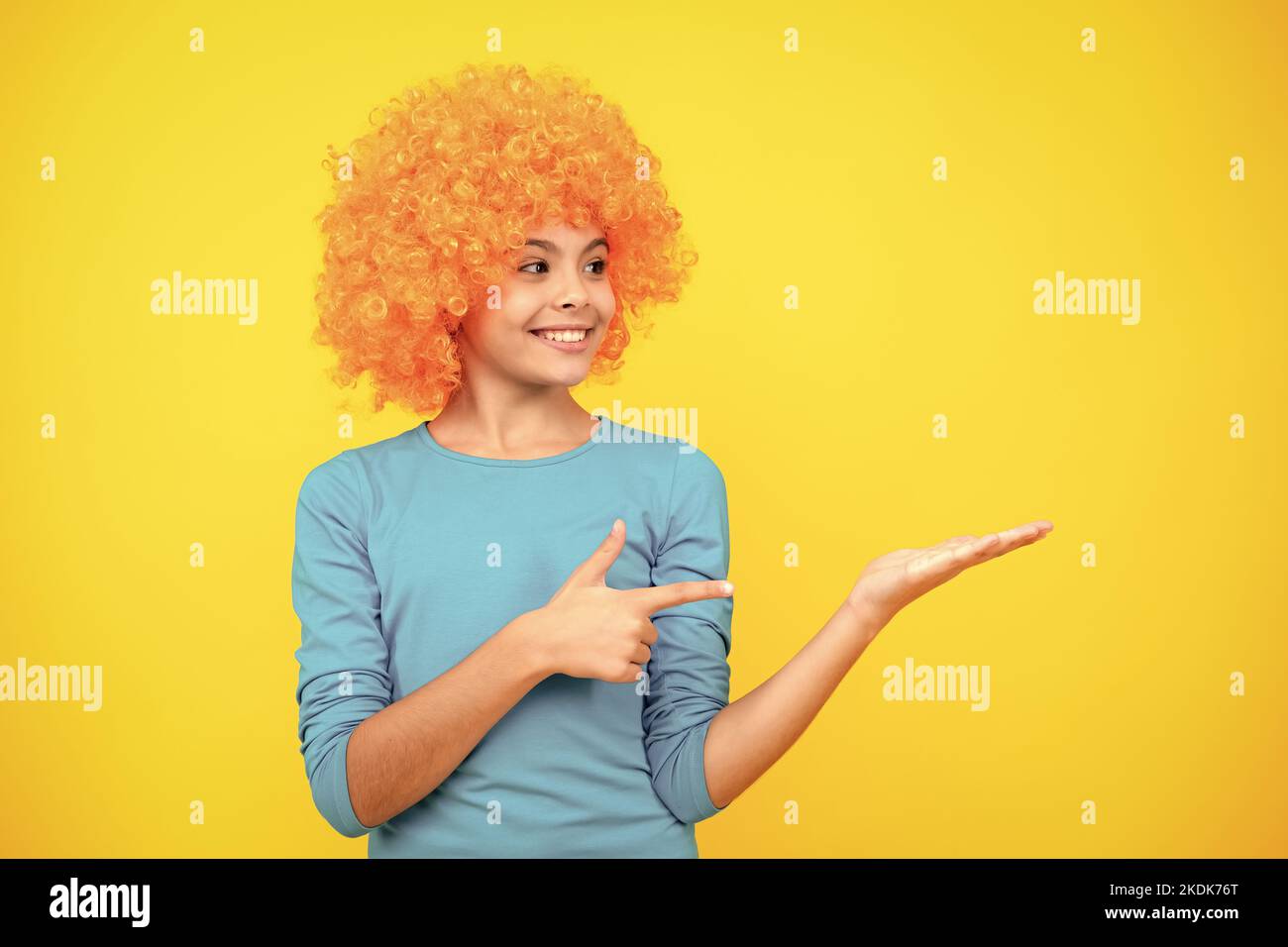 Happy teenager portrait. Teenage girl with yellow wig. Funny child ...