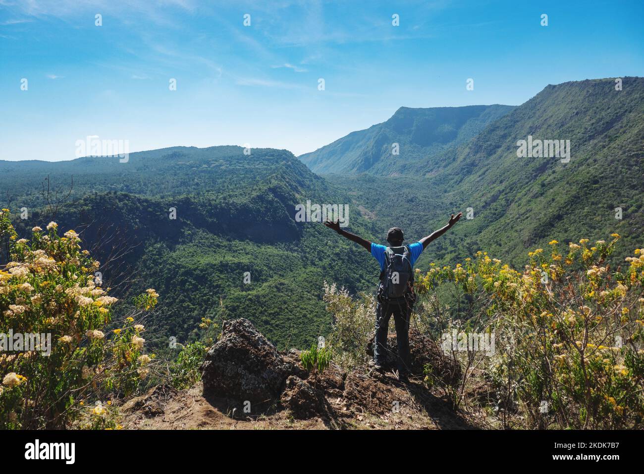 Rear view of a hiker against the volcanic crater on Mount Suswa, Kenya ...