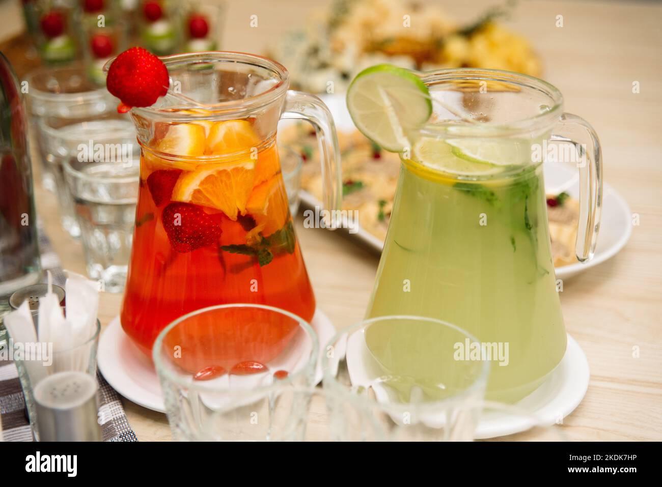 Citrus lemonades. Two pitchers of homemade lemonades. Lime slices, mint ...