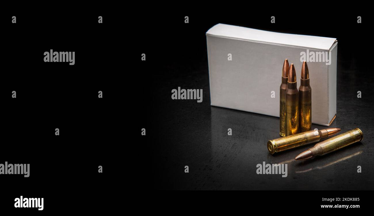 Bullet isolated on black background with reflexion. Rifle bullets close ...