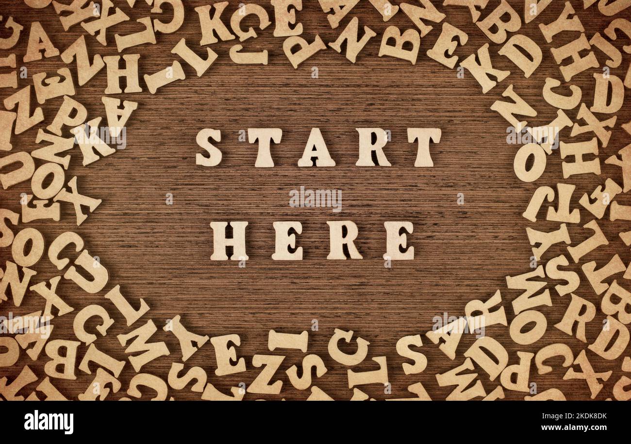 Start Here phrase made with wooden letters on table, concept Stock ...
