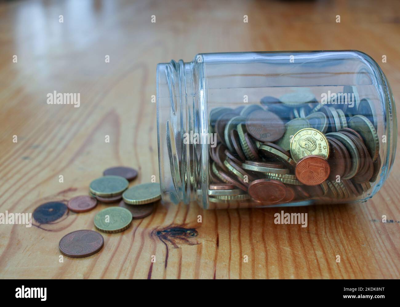 all the coins in the savings glass jar Stock Photo - Alamy
