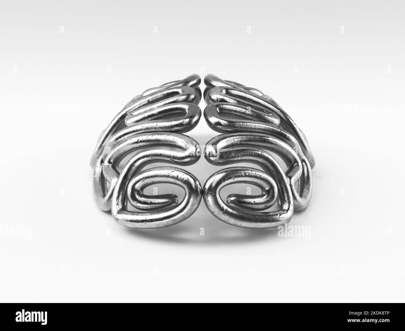 A metal casting depicting a stylized brain on an isolated background ...