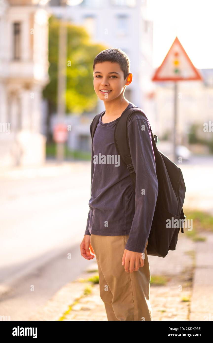 Cheerful teenager with the backpack on his back looking ahead Stock ...