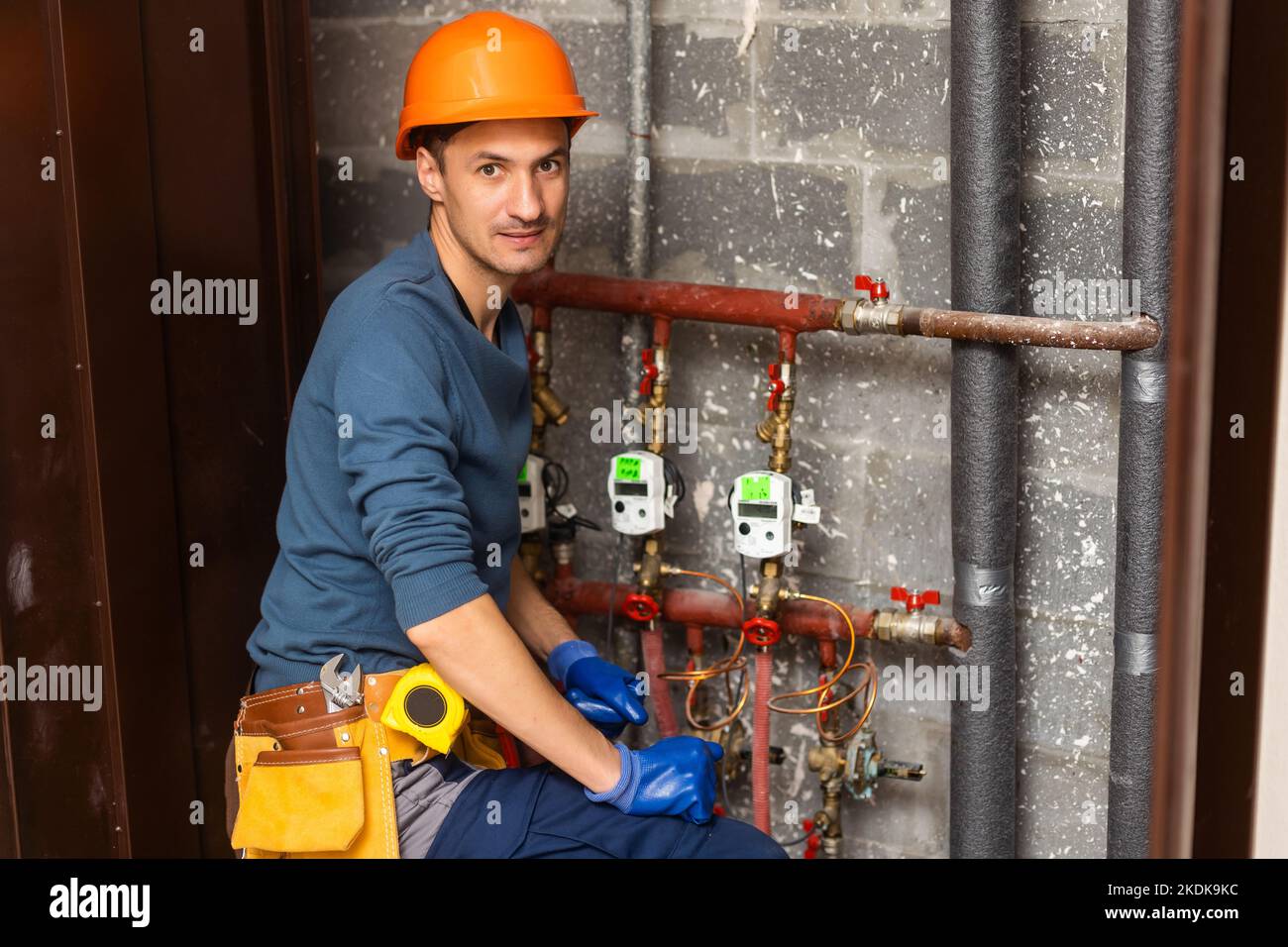 Technician inspecting heating system in boiler room Stock Photo - Alamy