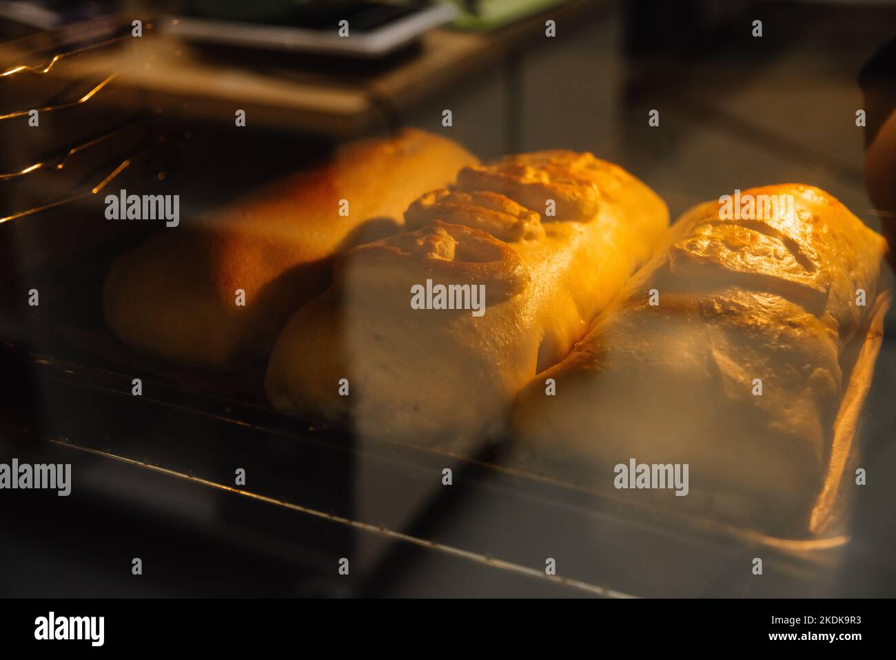 Three bread rolls baked in the oven until toasted with crunchy crust ...