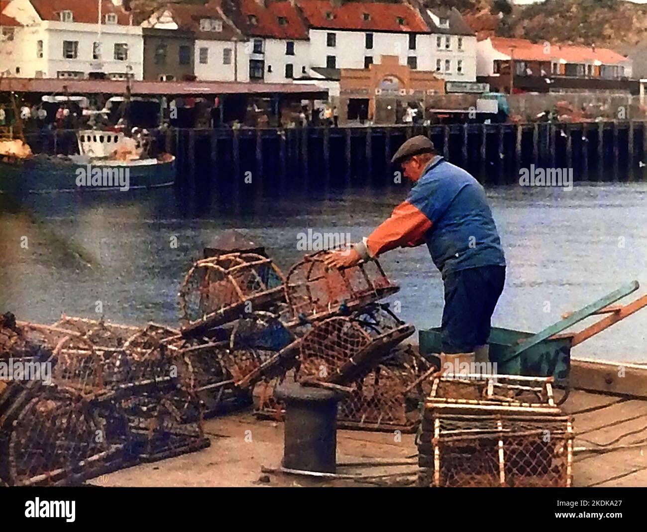 A vintage snapshot of a Whitby, Yorkshire fisherman stacking ...