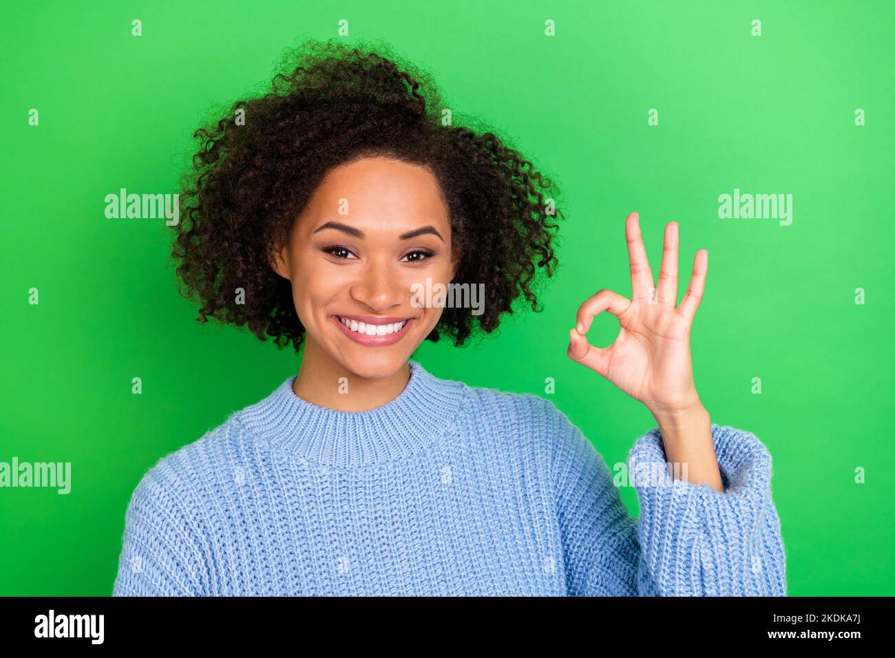 Photo of toothy beaming adorable girl with curly coiffure dressed blue ...
