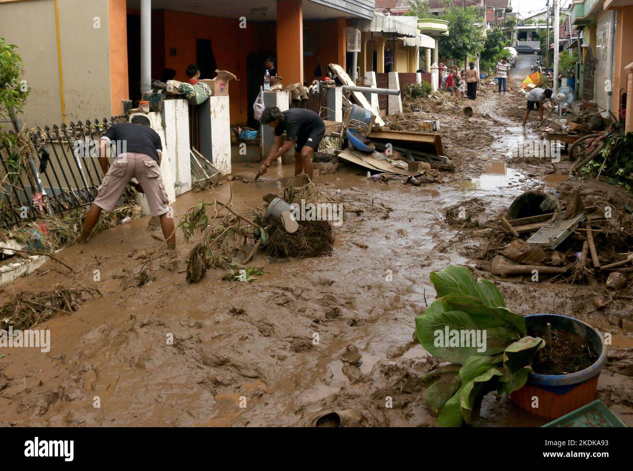 Semarang, Indonesia. 7th Nov, 2022. People clean mud in front of their ...