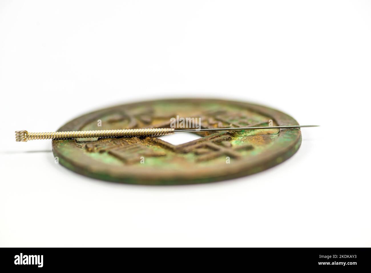 Acupuncture needle on chinese antique coin Stock Photo - Alamy